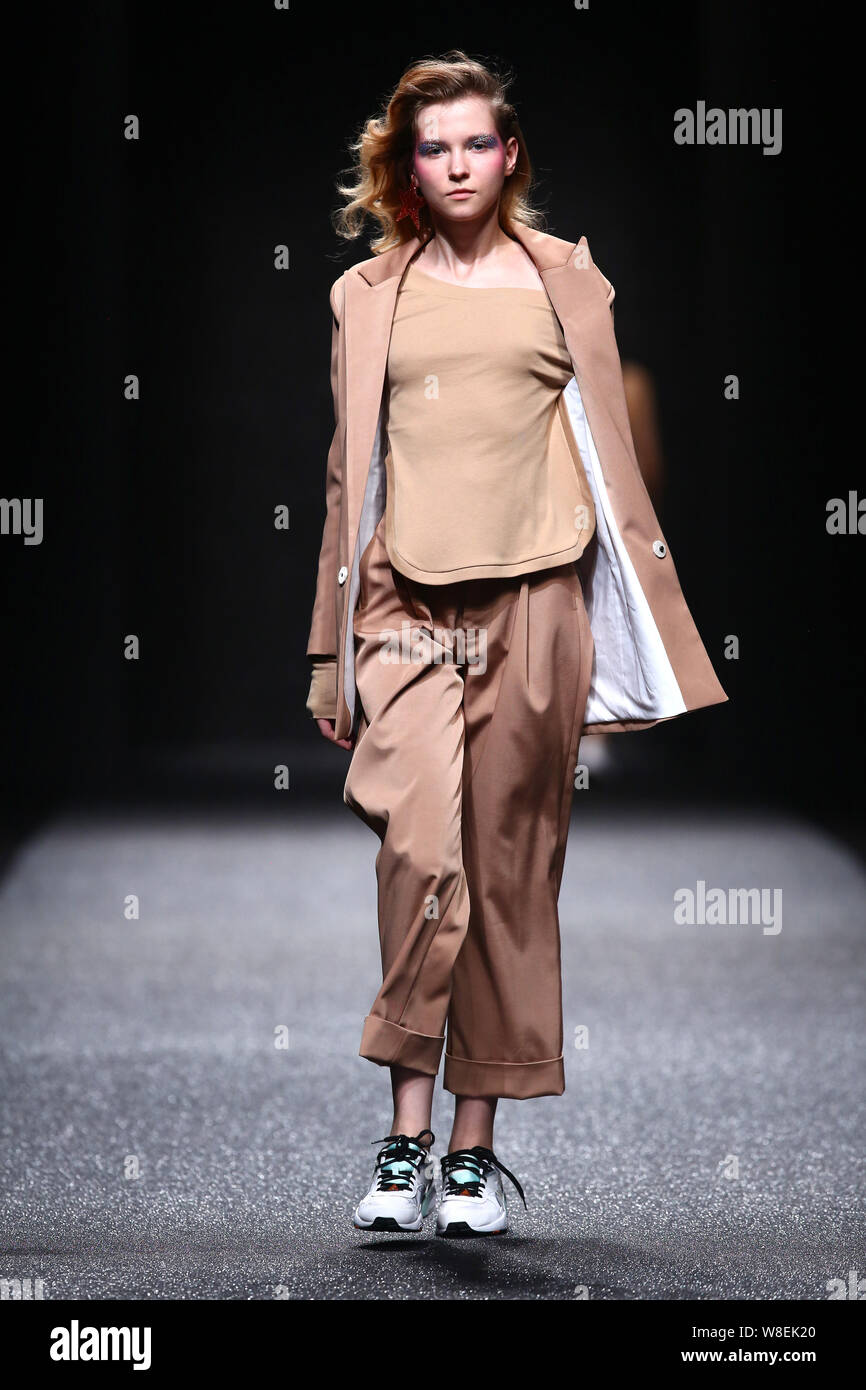 A model displays a new creation at the Nicole Zhang fashion show during ...