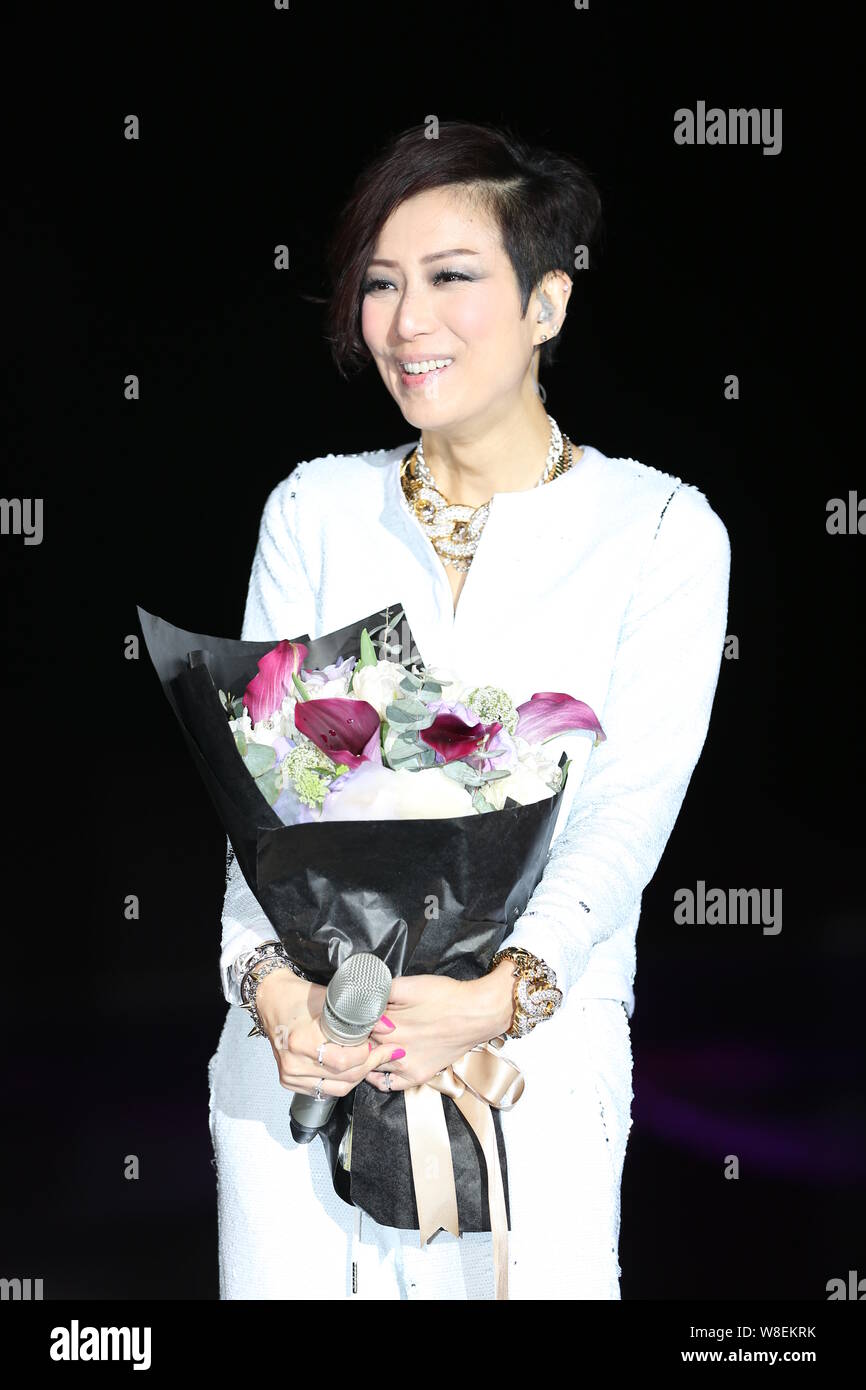 Hong Kong singer Sammi Cheng holds a bouquet of flowers during an event ...