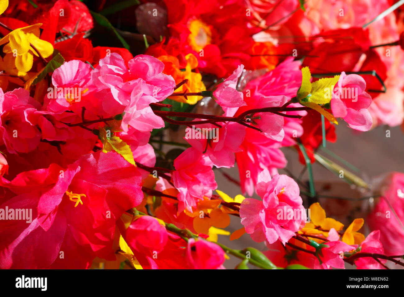Colorful artificial flowers, color area Stock Photo - Alamy