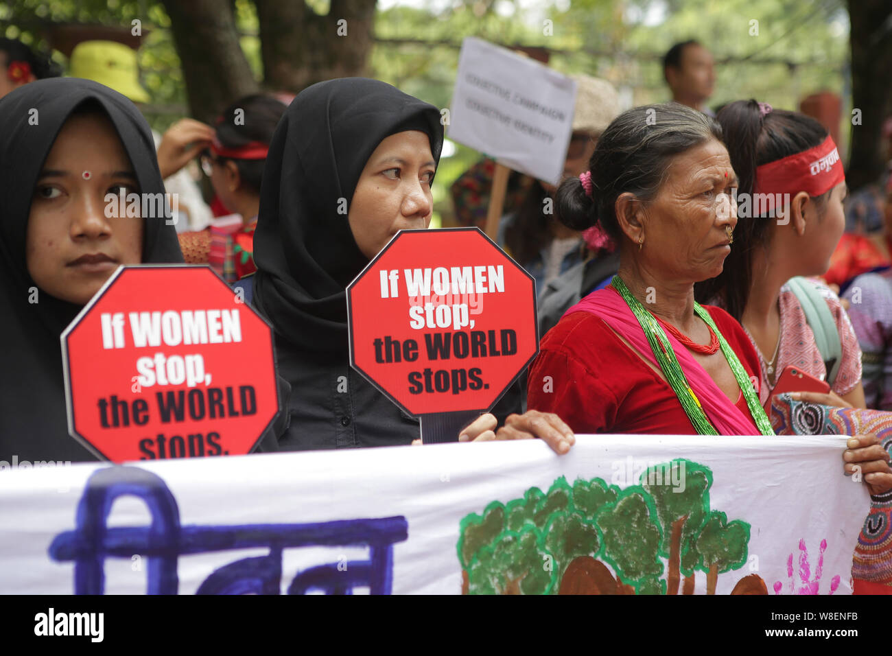 Nepalese Indigenous women hold placards and a banner during the march ...