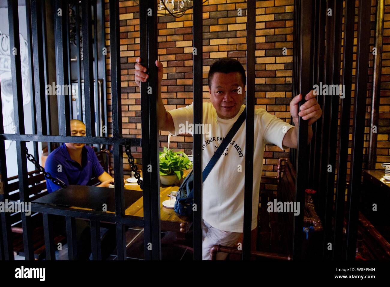 Customers are pictured in a dining room at a prison-themed restaurant ...