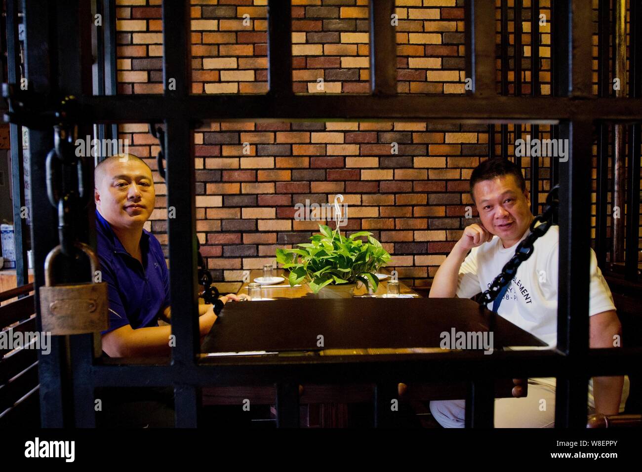 Customers are pictured in a dining room at a prison-themed restaurant ...