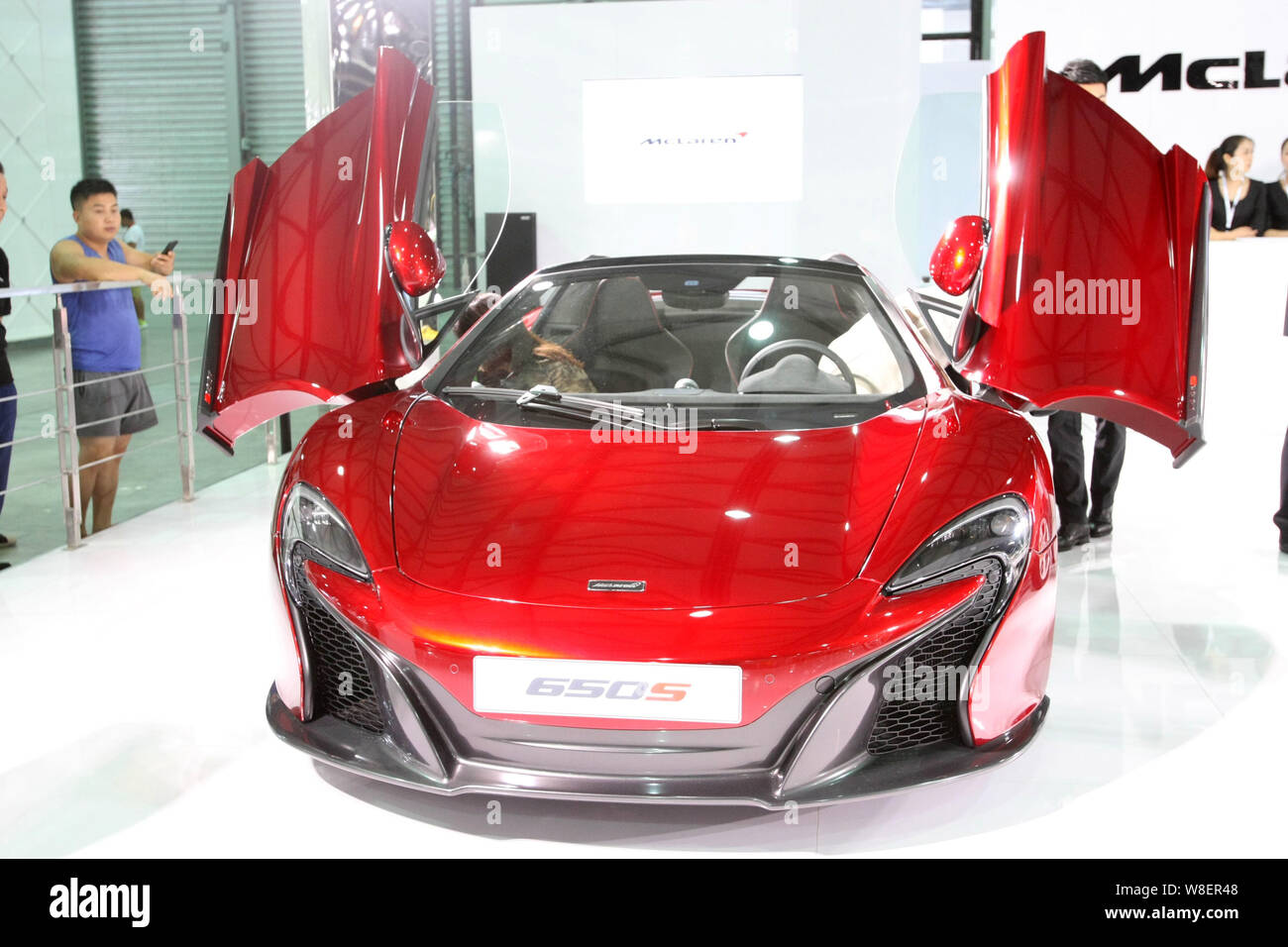 --FILE--A visitor tries out a McLaren 650S sports car during the 2014 ...