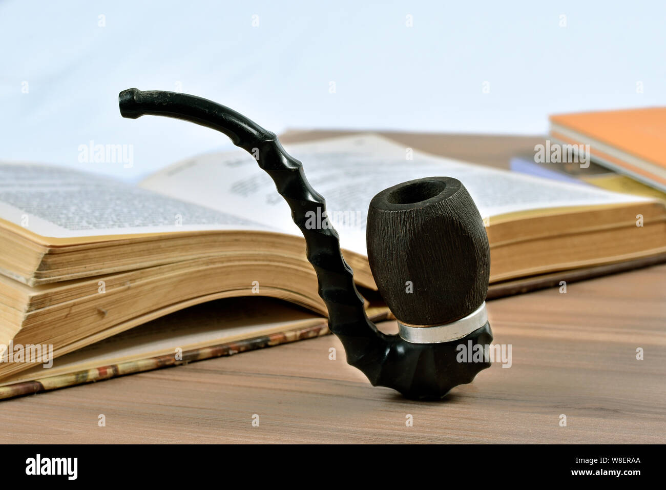 pipe, old book on the table Stock Photo - Alamy