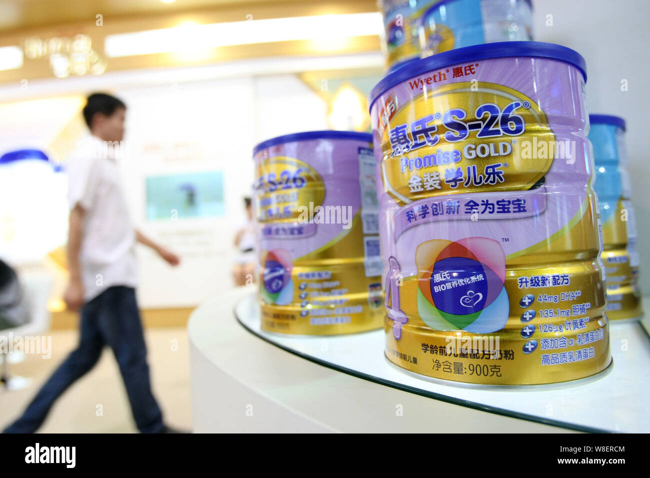 --FILE--A visitor walks past tins of Wyeth baby formula during an ...