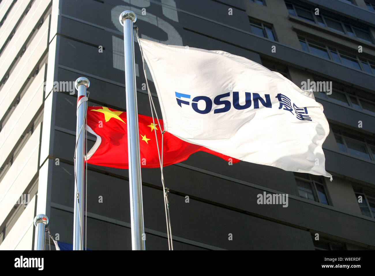 --FILE--Flags of China and Fosun flutter at the headquarters of Fosun ...