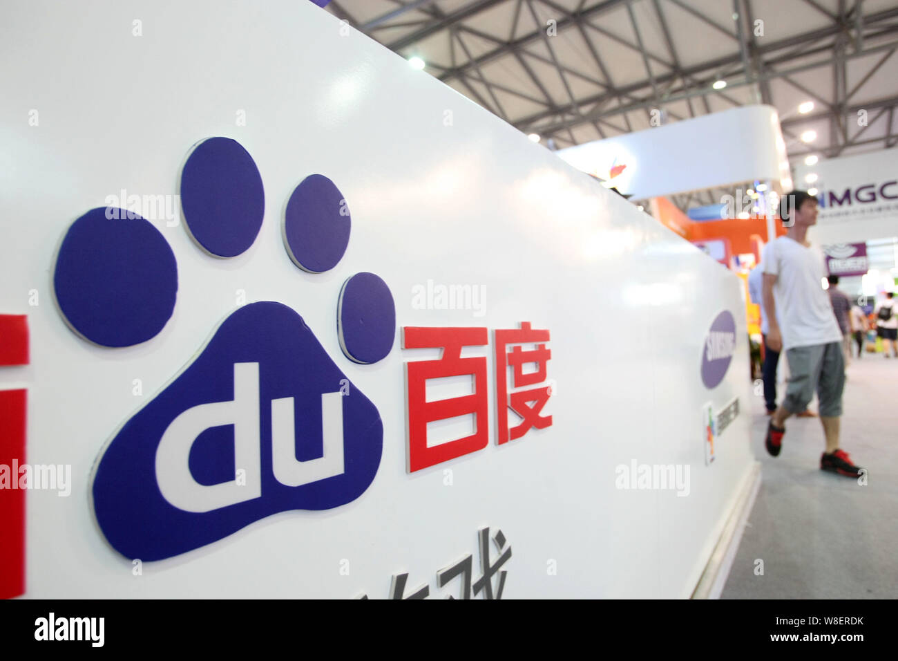 --FILE--A visitor walks past the stand of Baidu during an exhibition in ...