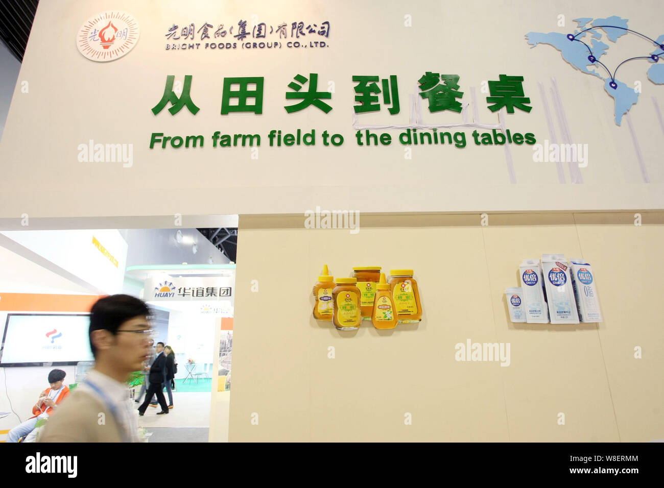 --FILE--A visitor walks past the stand of Bright Food (Group) Co., Ltd ...