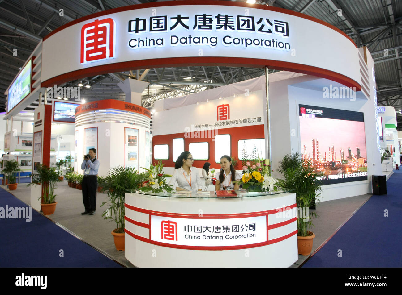 --FILE--Chinese employees are seen at the stand of China Datang ...