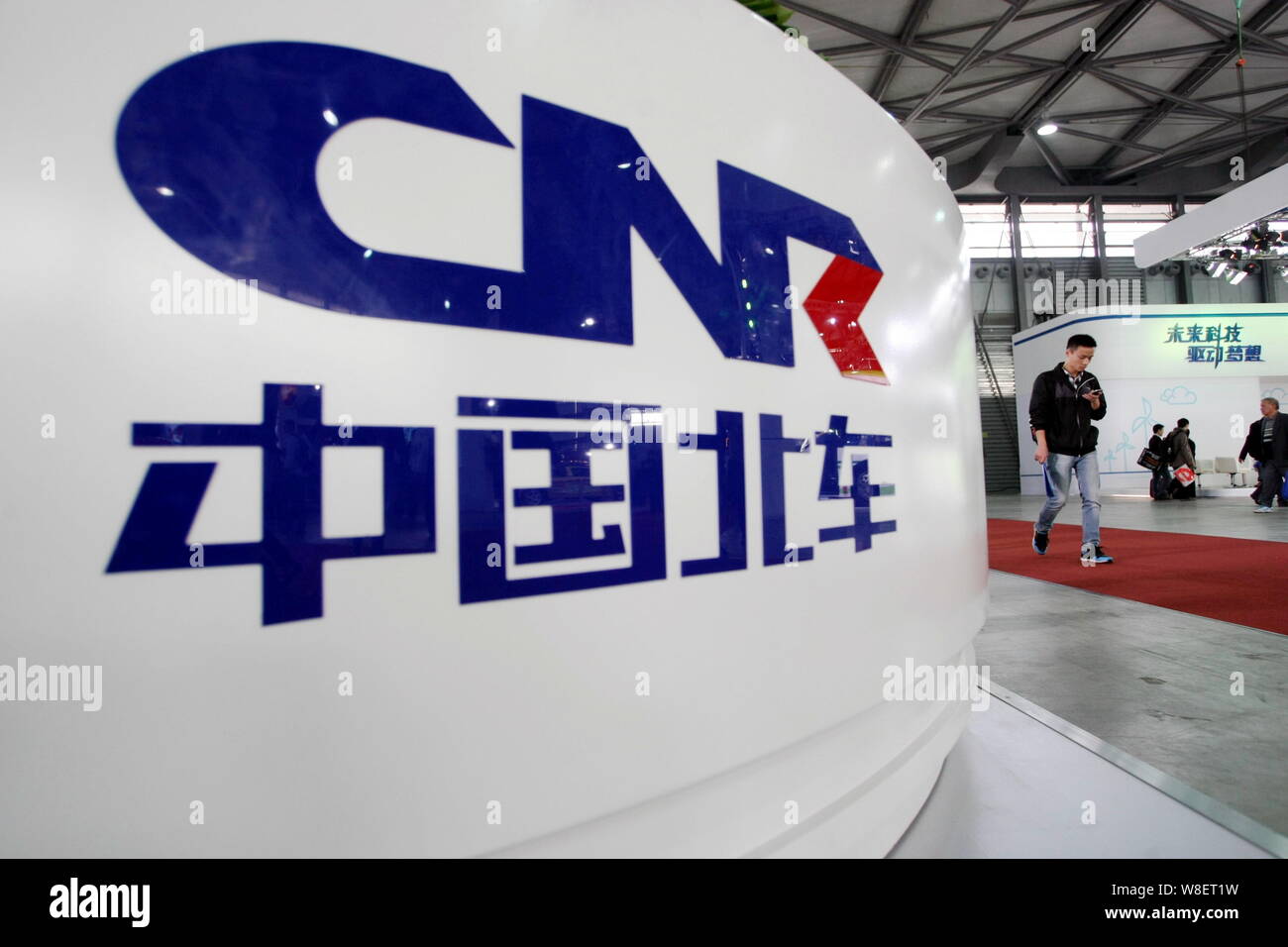 --FILE--A visitor walks past the stand of CNR (China Northern ...