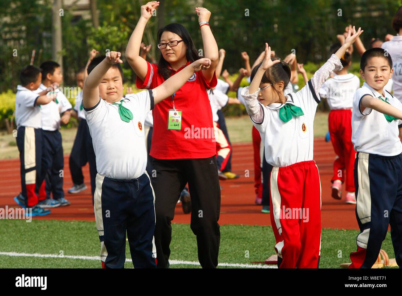 --FILE--Young Chinese students do physical exercises during a citywide ...