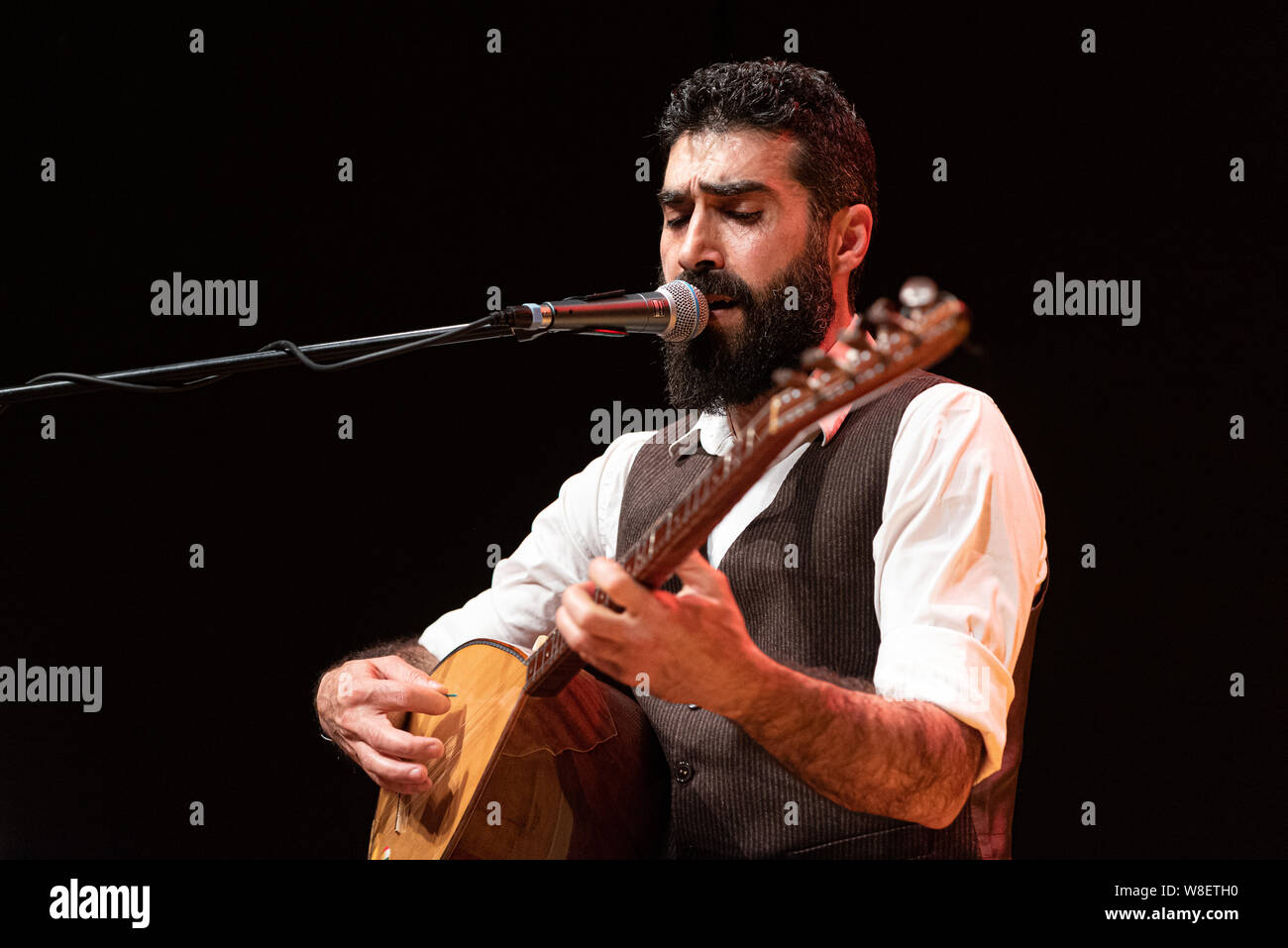 Good-looking man with a thick black beard, musician playing a typical ...