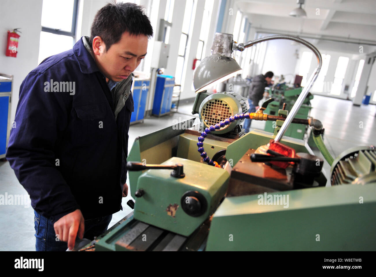 --FILE--A Chinese worker handles production of electro-hydraulic servo ...