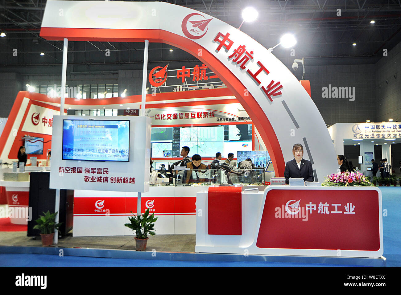 --FILE--A Chinese employee is seen at the stand of AVIC (Aviation ...