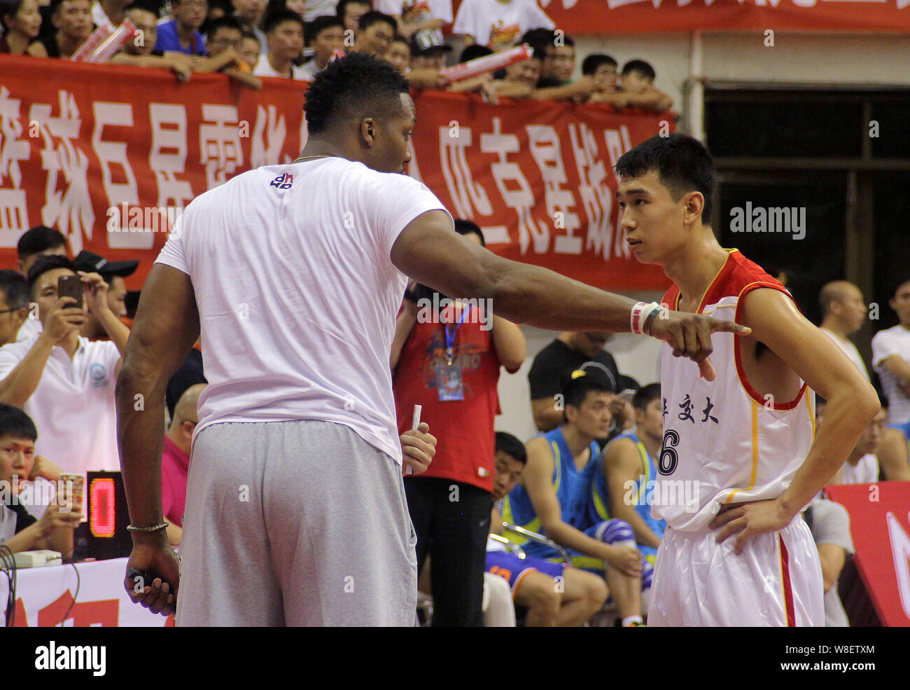 NBA star Dwight Howard, left, gives instructions to a young Chinese boy ...