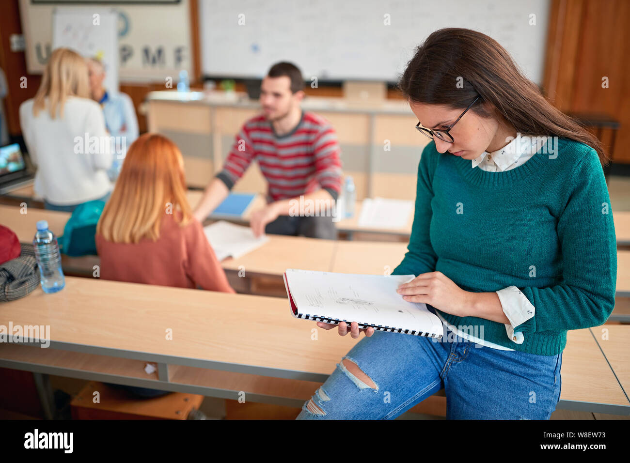 Female college student in a classroom learning Stock Photo - Alamy