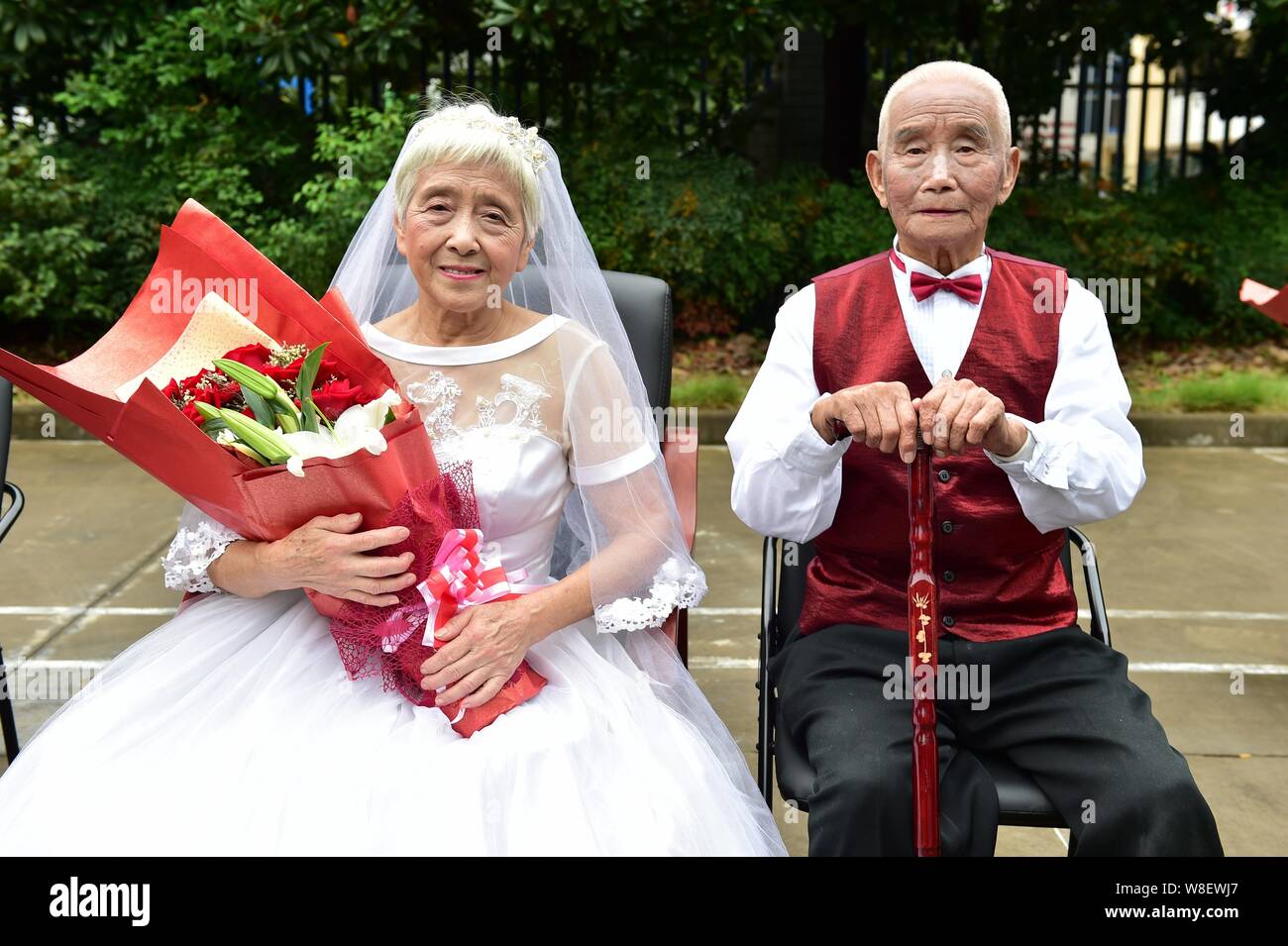 An elderly couple pose for wedding photos to celebrate their wedding ...