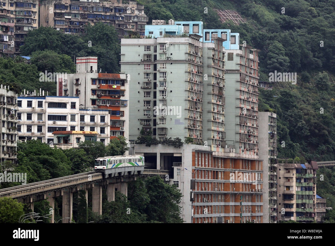 --FILE--A monorail train passes through residential apartment buildings ...