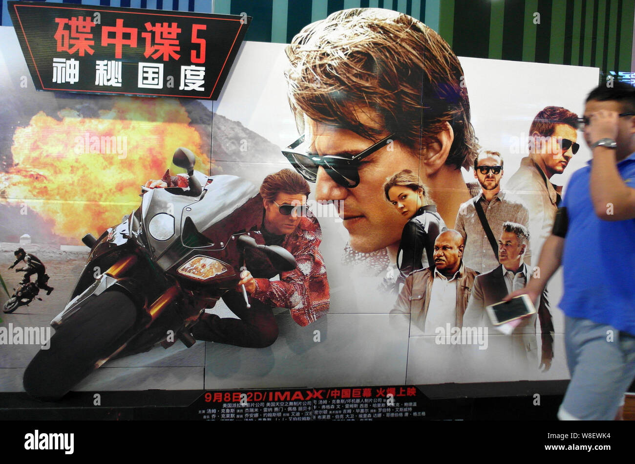 --FILE--A Chinese filmgoer walks past a poster for the "Mission ...