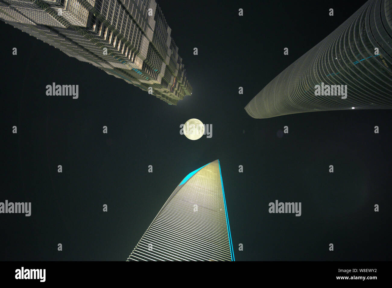 Night view the moon among the Shanghai Tower, right, the Shanghai World ...