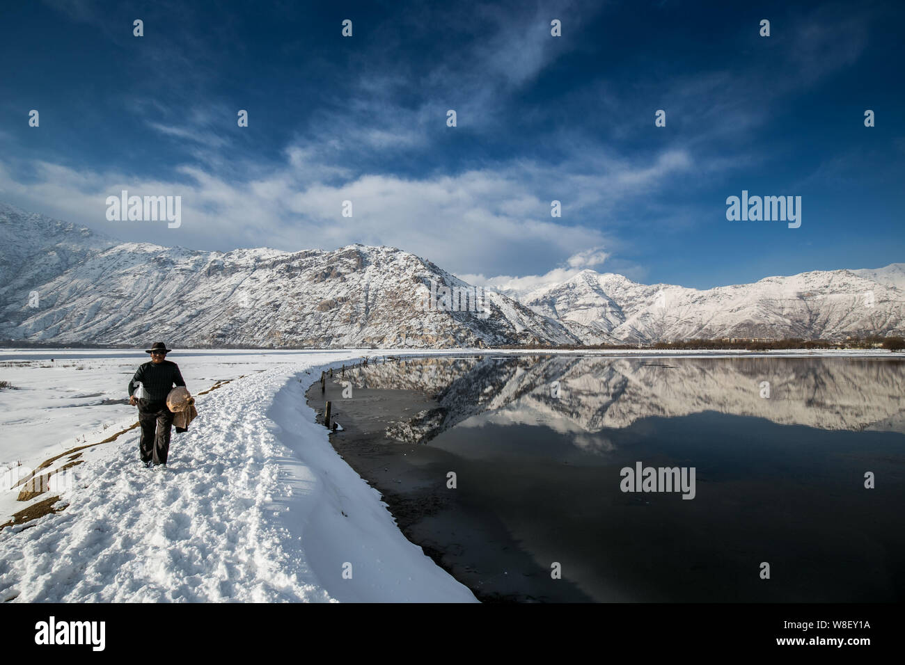 --FILE--A local resident walks in the snow in the Lhalu Wetland ...