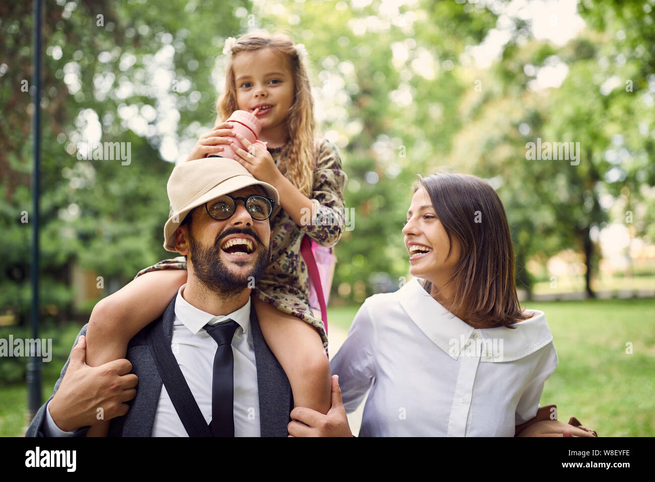 happy family walking together in park after school Stock Photo - Alamy