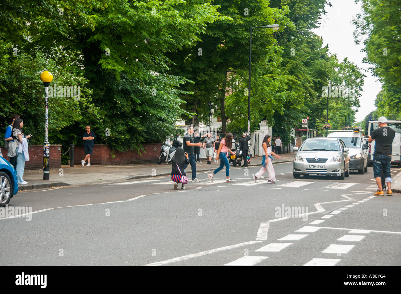 Tourists following in the footsteps of the Beatles on the pedestrian ...