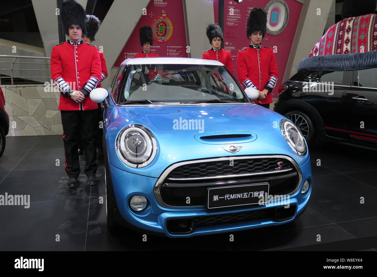 --FILE--Models pose with a Mini car of BMW during an event in Beijing ...