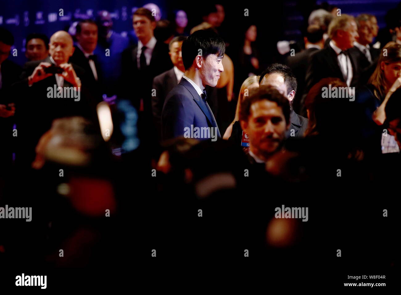 Retired Chinese hurdling star Liu Xiang, center, arrives on the red ...