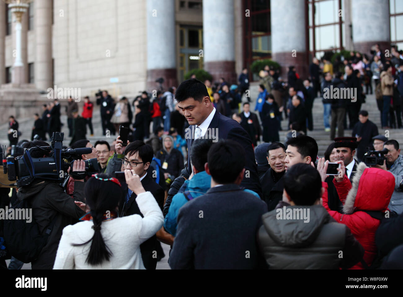 Retired Chinese basketball superstar Yao Ming, center, is surrounded by ...