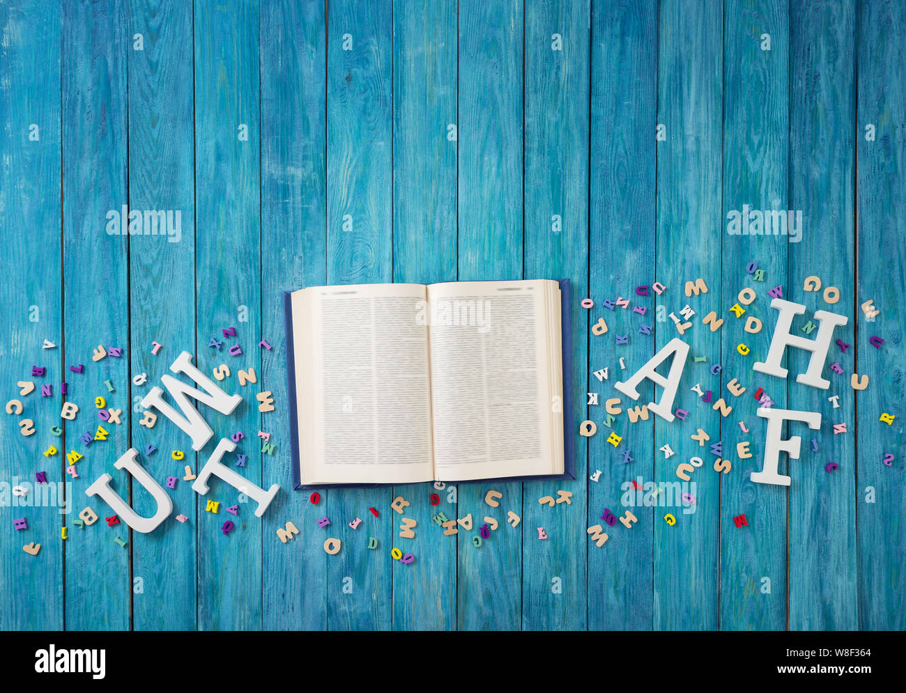 Open book on blue painted planks Stock Photo - Alamy