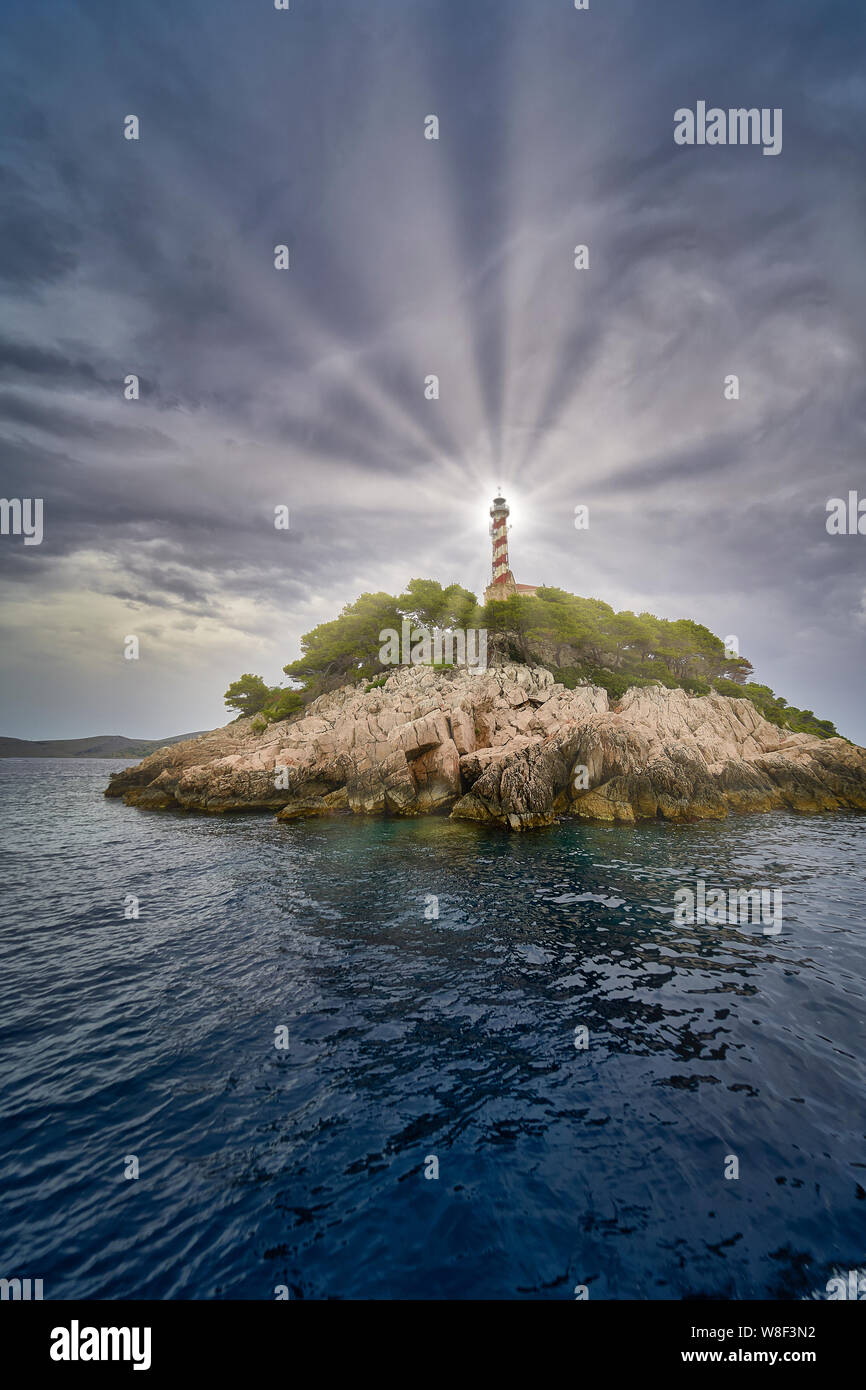 Little island with a lighthouse Stock Photo - Alamy