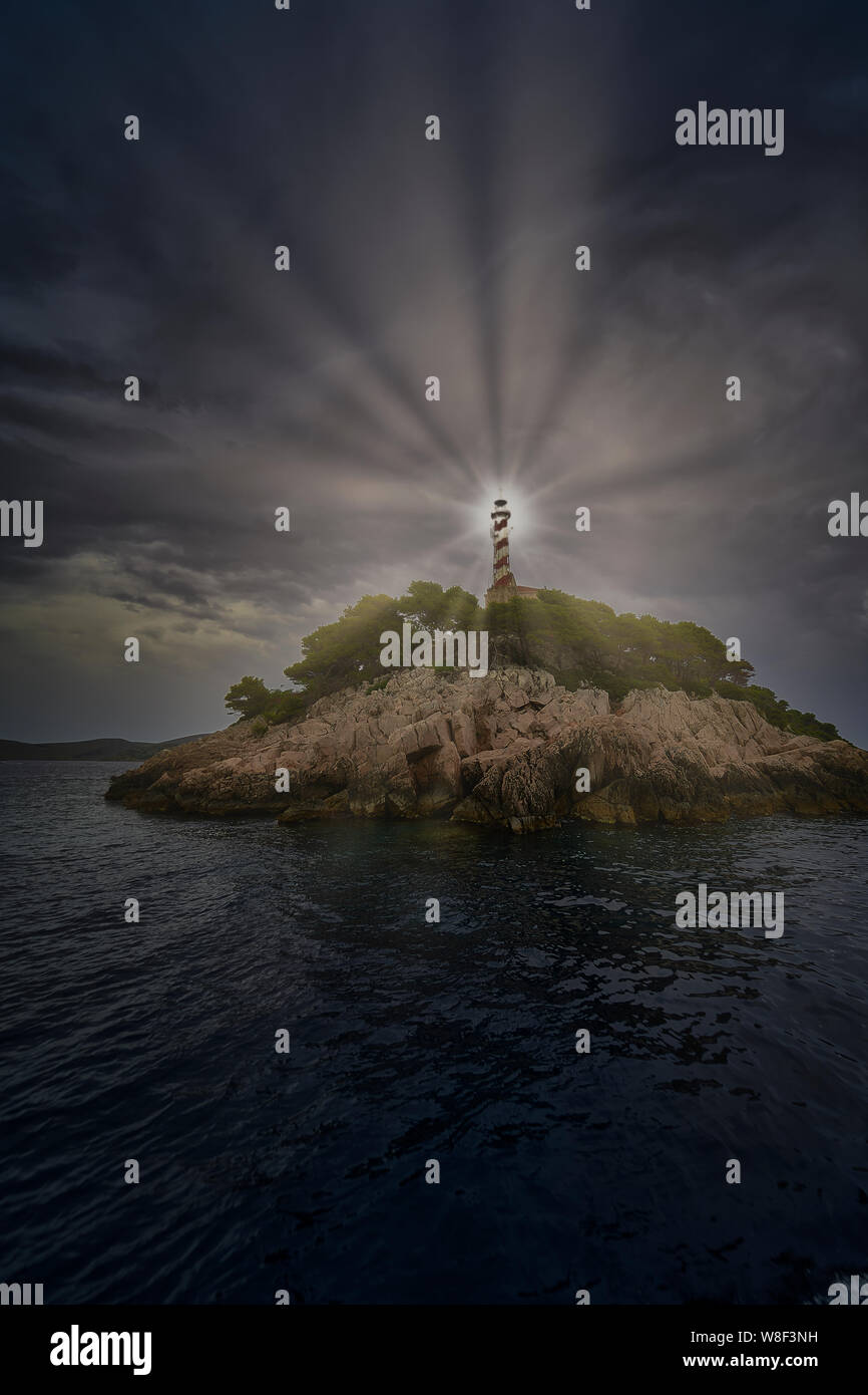 Little island with a lighthouse Stock Photo - Alamy