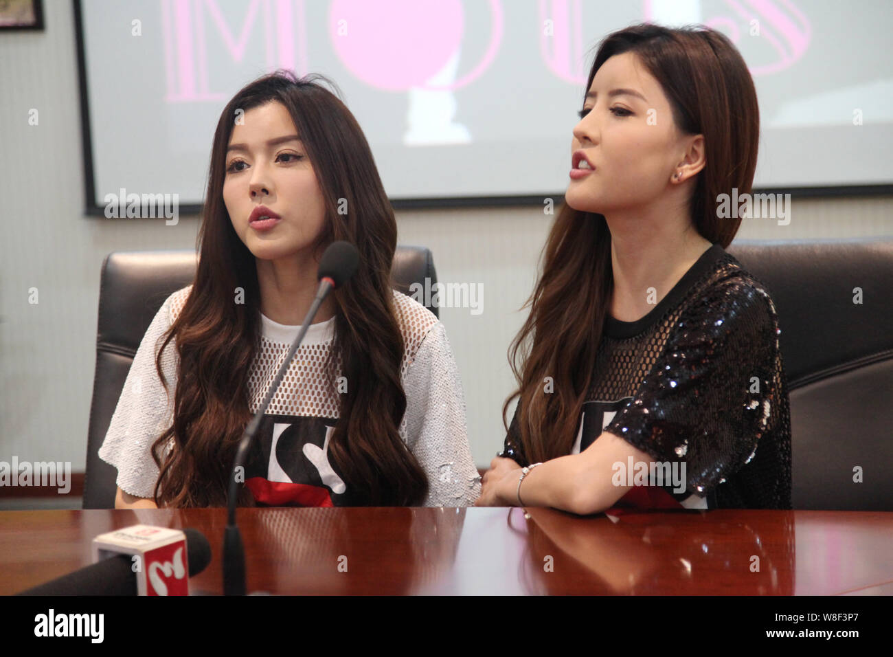 The twin sisters Miko and Yumi of Singaporean pop duo BY2 attend a ...