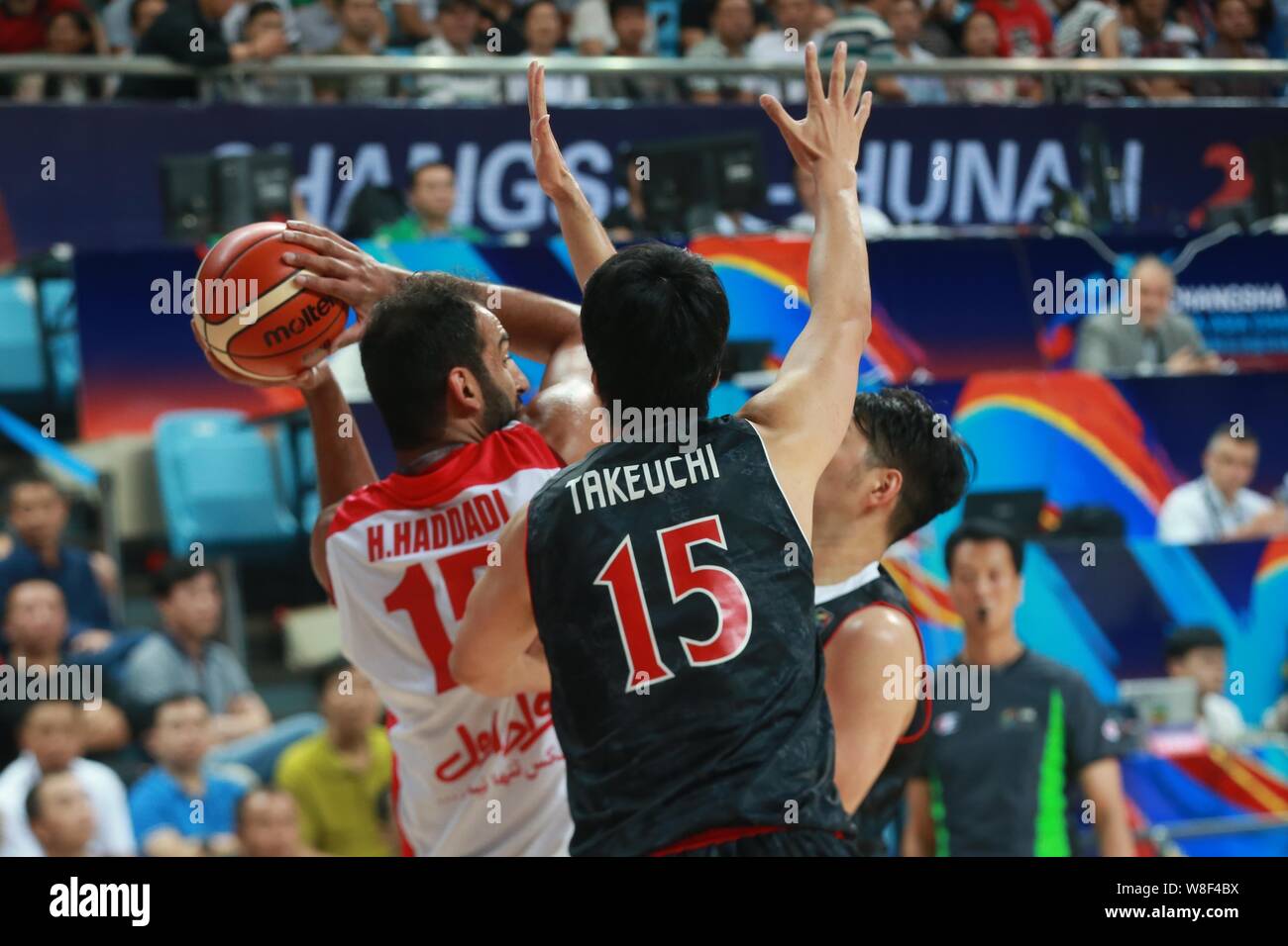 Joji Takeuchi of Japan, right, challenges Hamed Ehadadi of Iran in a ...