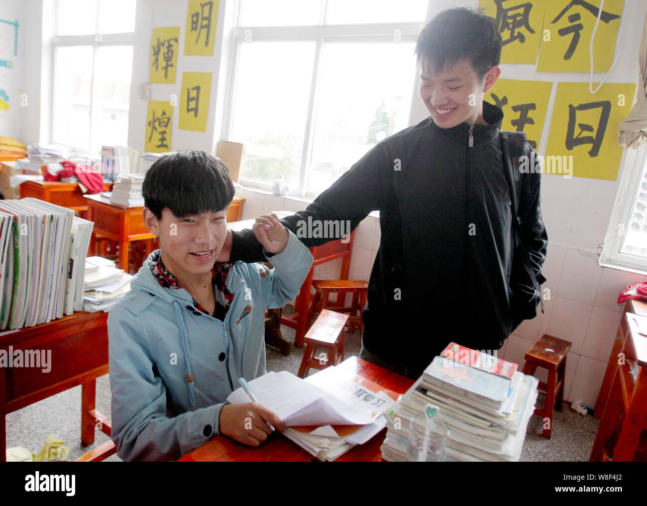 Chinese student Xie Xu, right, interacts with his disabled classmate ...