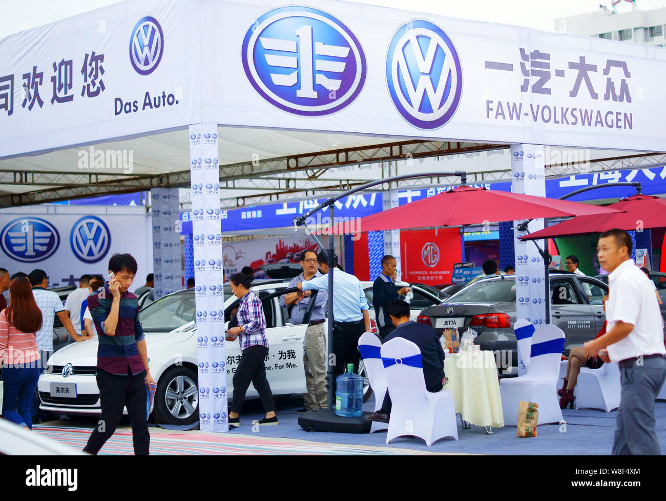 --FILE--Visitors look at cars of FAW-Volkswagen, a joint venture ...