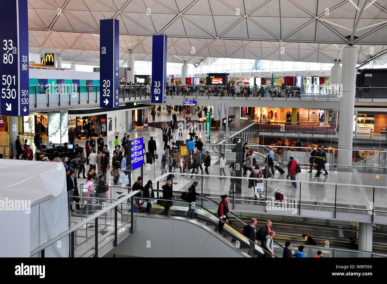 --FILE--Passengers walk at the terminal of the Hong Kong International ...