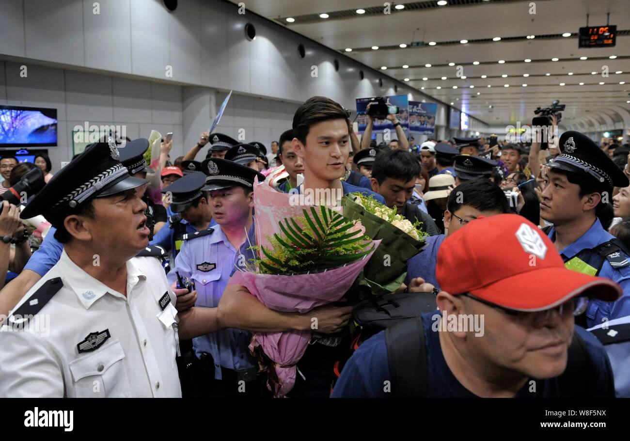 Sun Yang, center, of the Chinese national swimming team and teammates ...