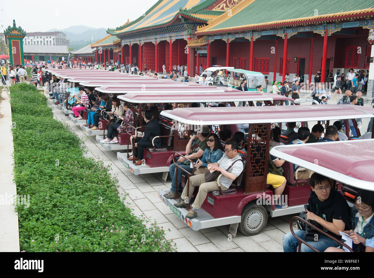 People take sightseeing vehicles to visit the full-scale replica of the ...