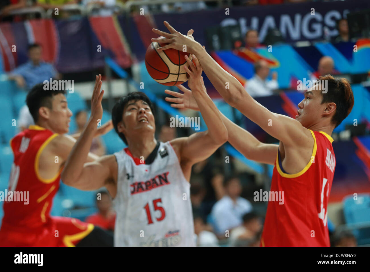 A player of Malaysia, right, challenges Joji Takeuchi of Japan in a ...