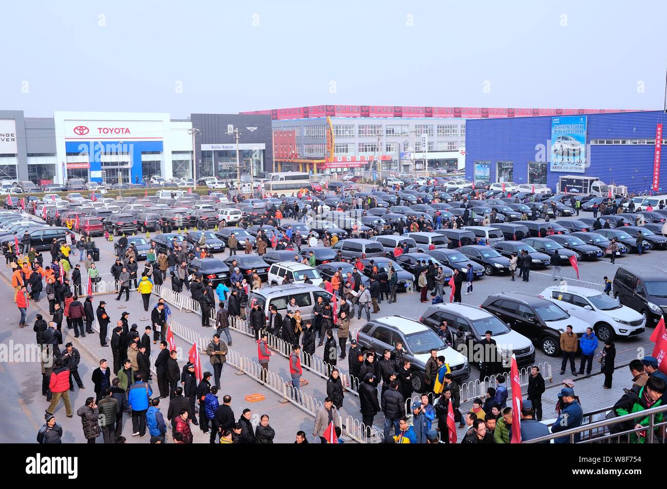 --FILE--Chinese car buyers look at government cars to be auctioned at a ...