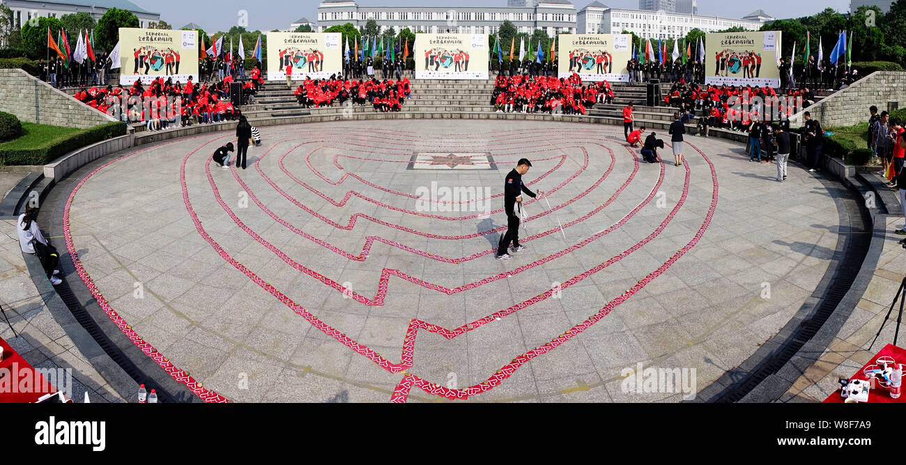 Chinese charity activists measure the length of the longest line of ...