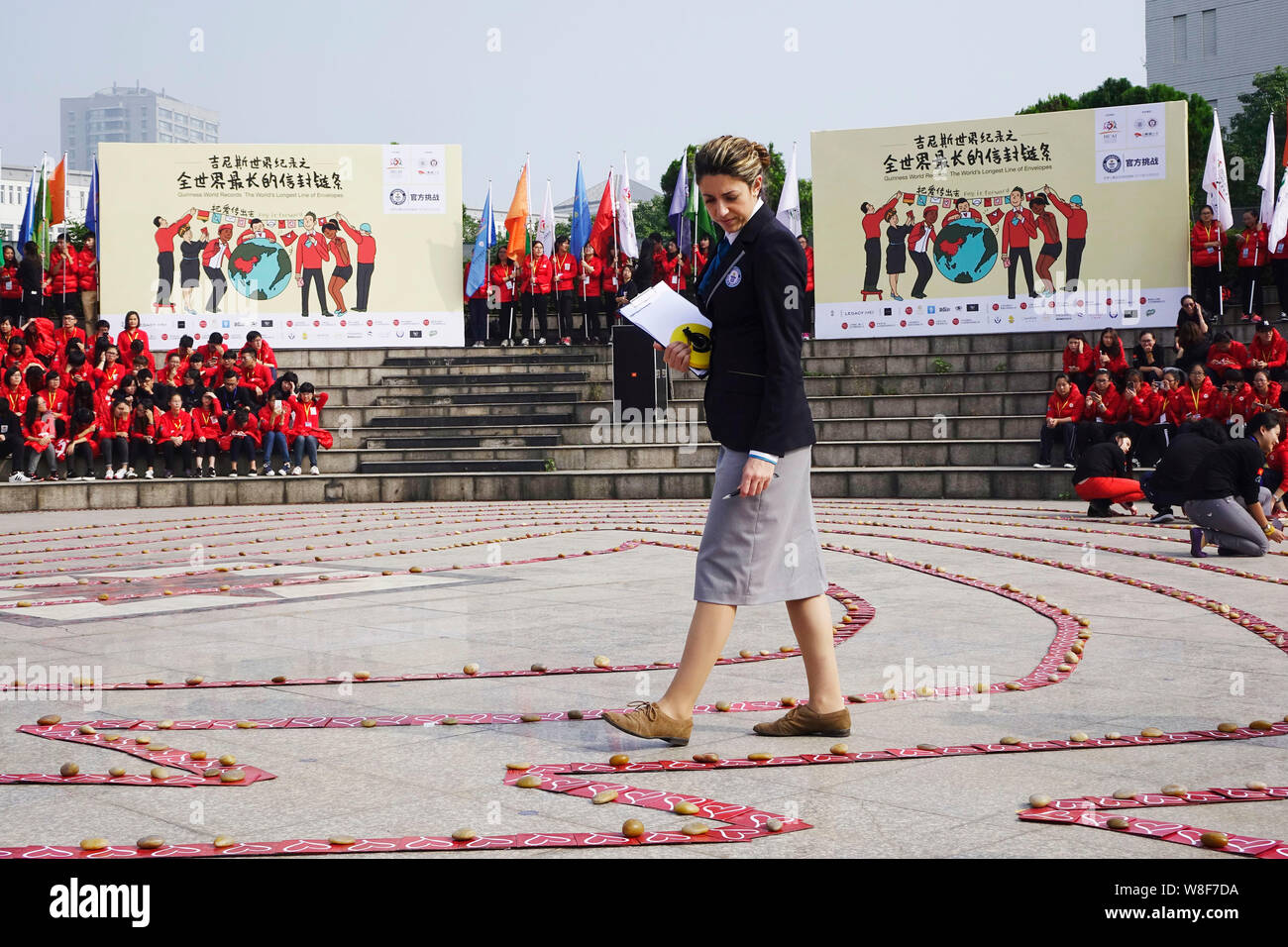 An official from Guinness World Records counts the envelopes used to ...