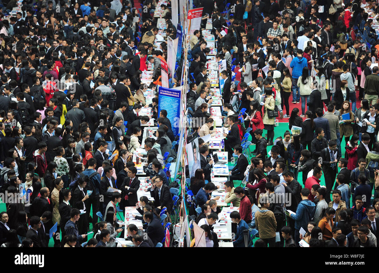 Chinese students and graduates crowd booths during a job fair at Anhui ...