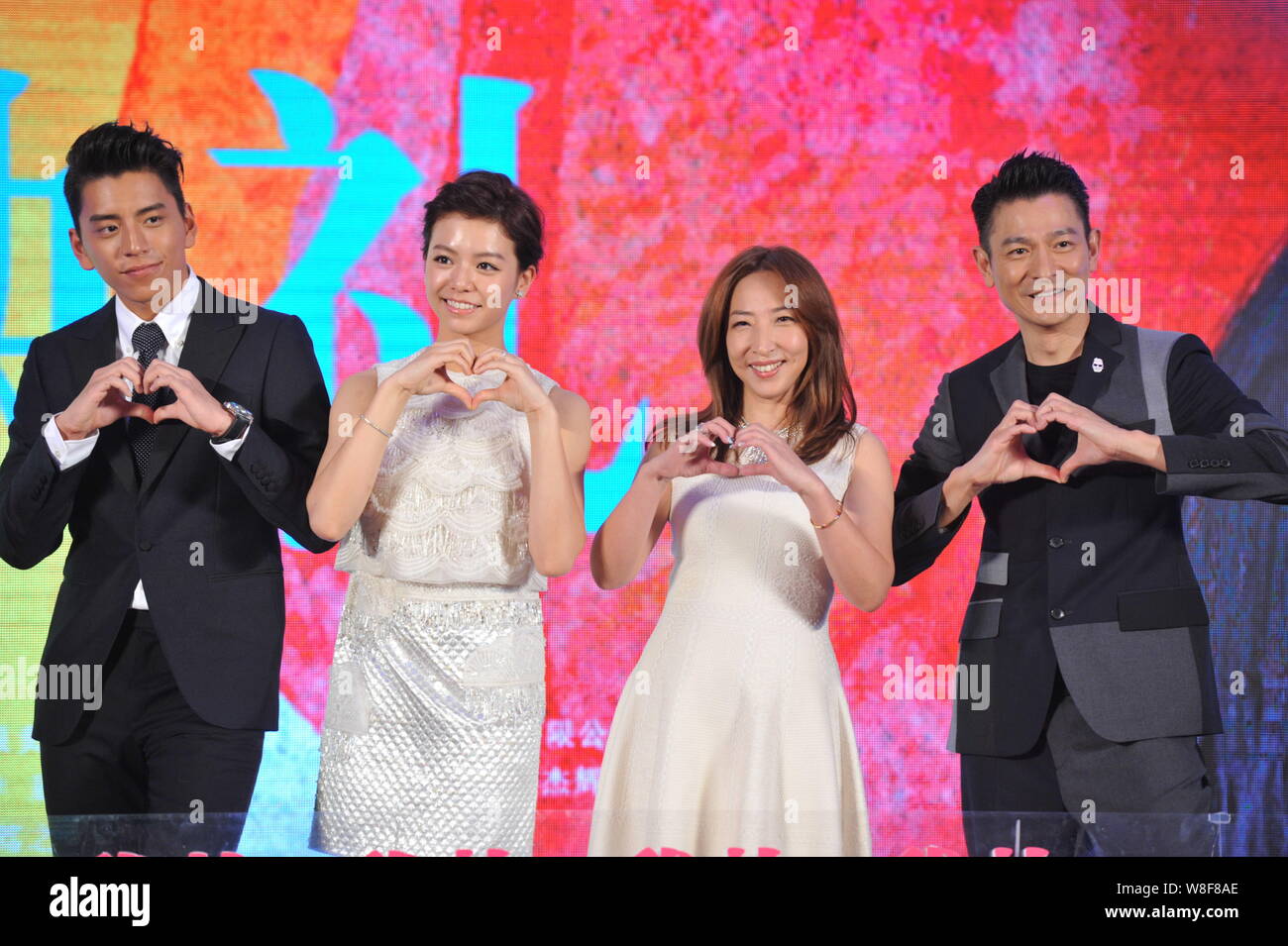 Hong Kong singer and actor Andy Lau, right, poses during a premiere for ...
