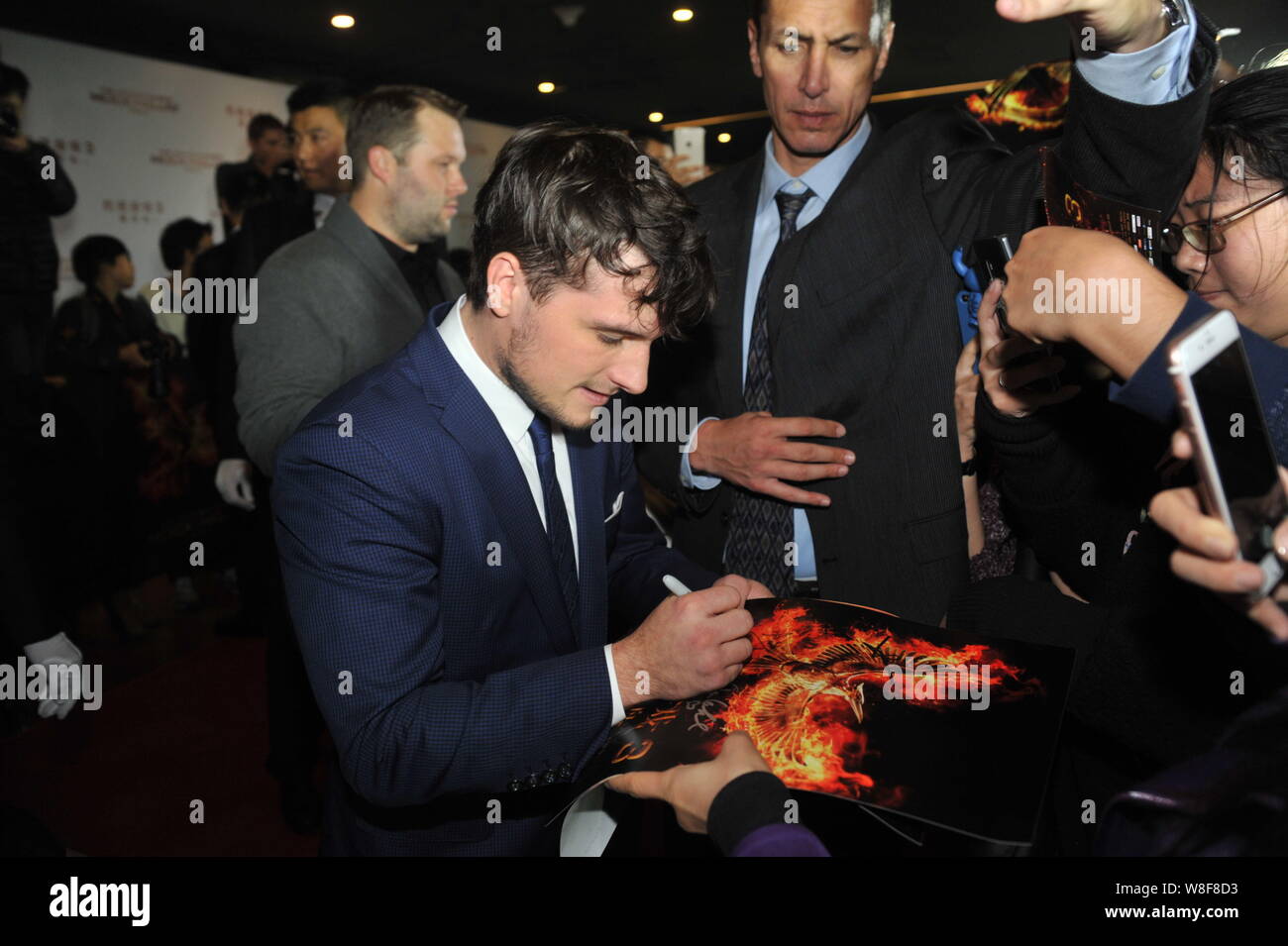 American actor Josh Hutcherson, center, signs autographs for fans at a ...