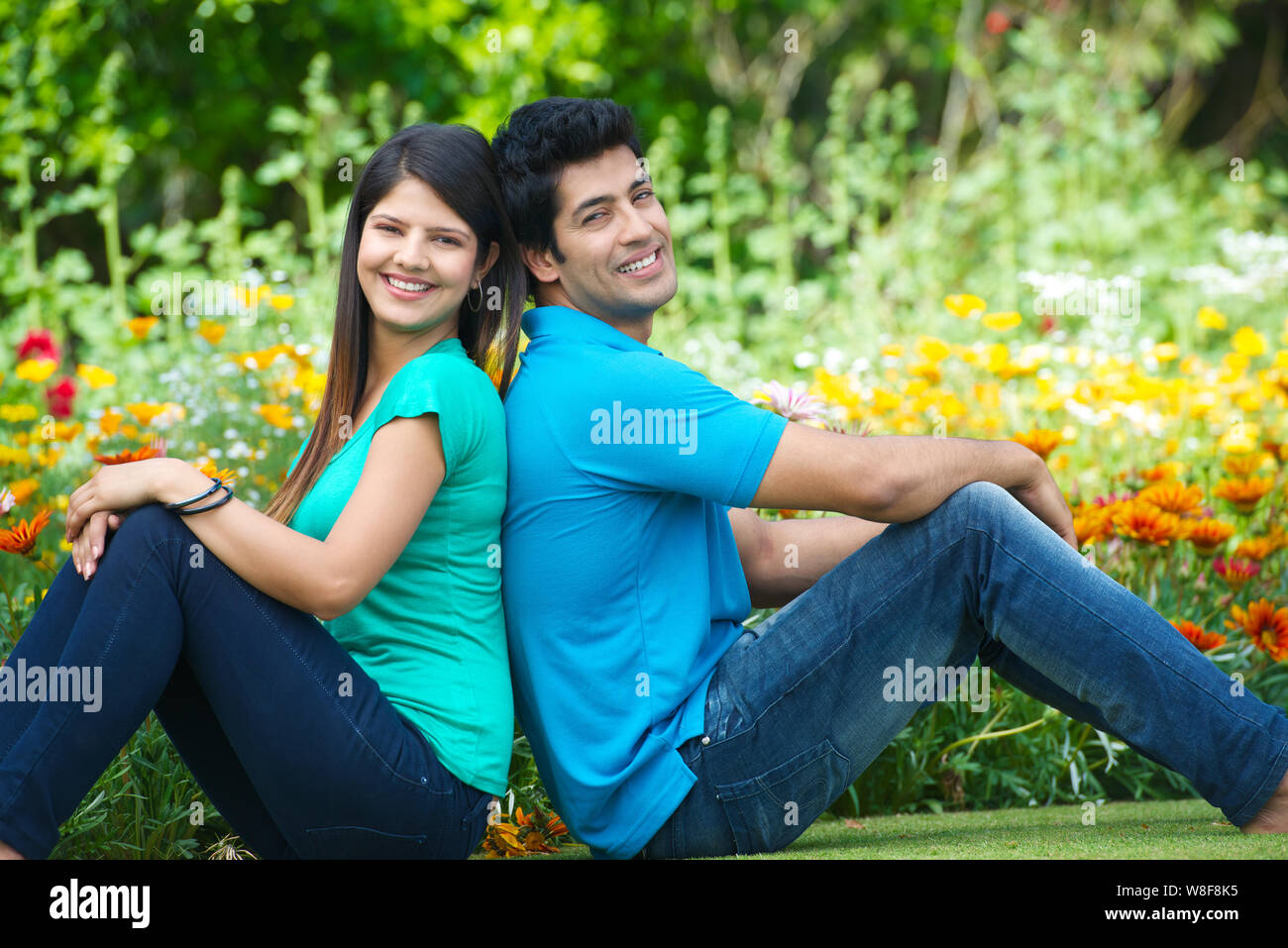 Couple sitting back to back in garden hi-res stock photography and ...