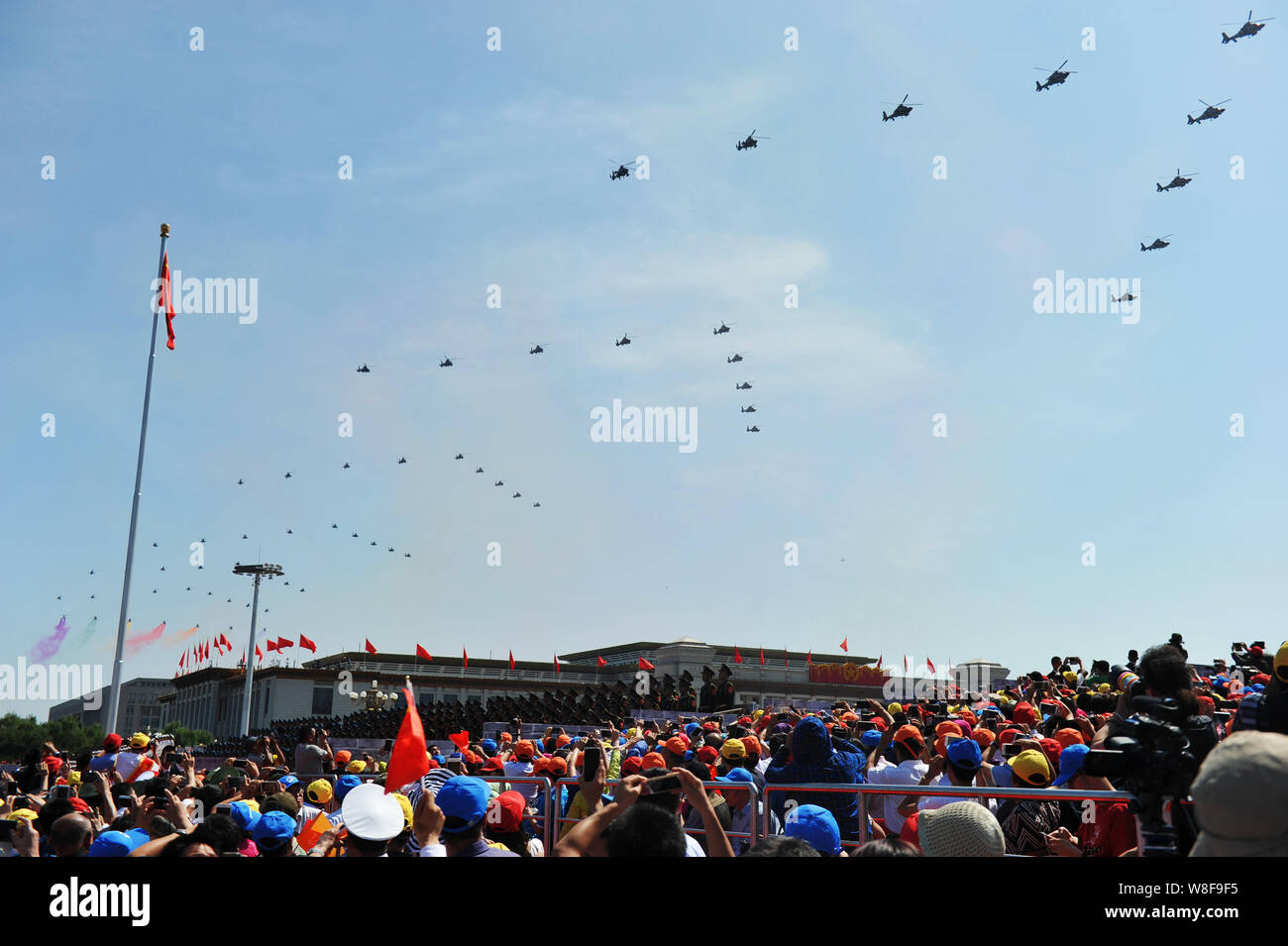 Military helicopters fly in formation over Tiananmen Square during the ...