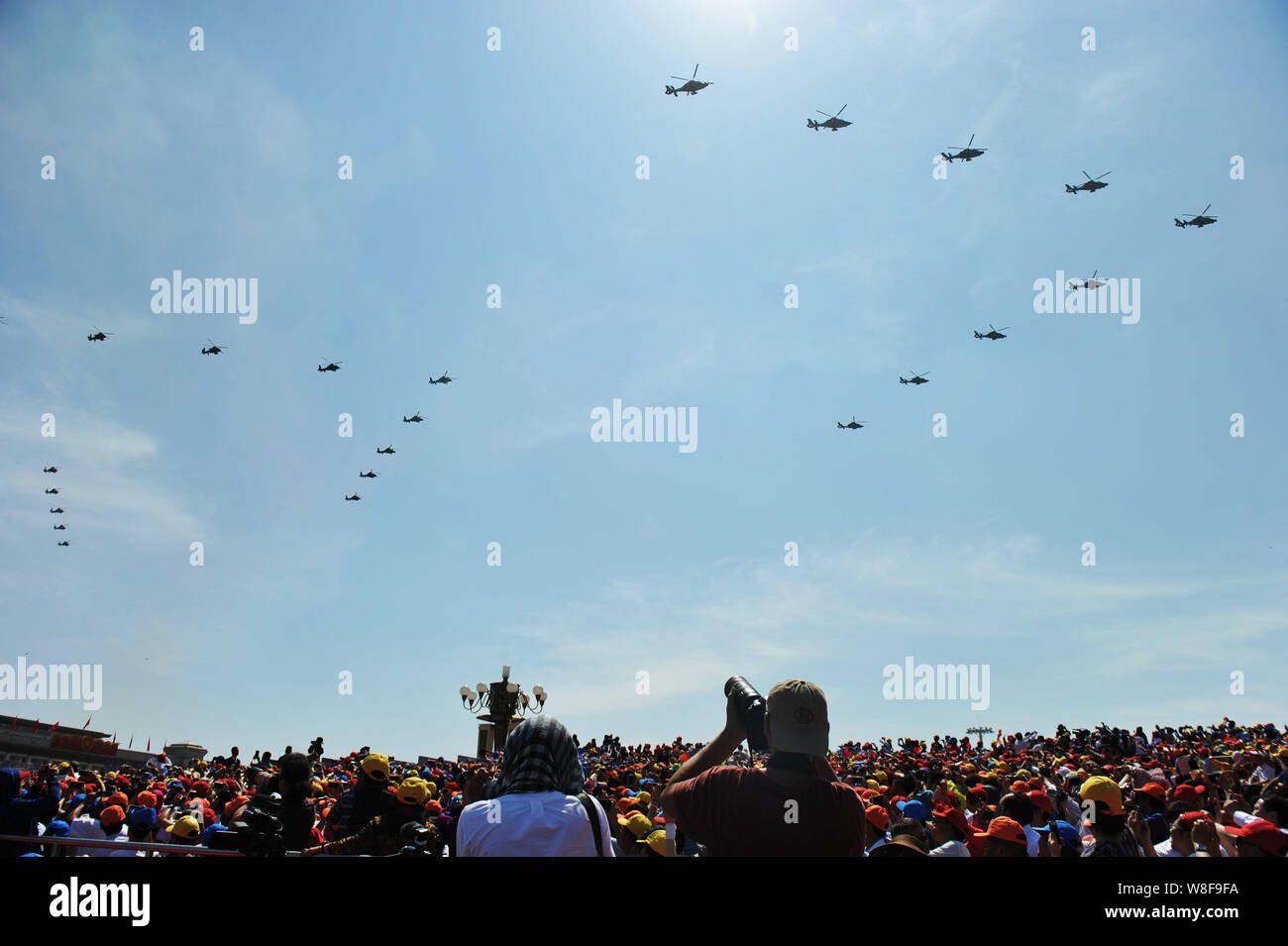 Military helicopters fly in formation over Tiananmen Square during the ...